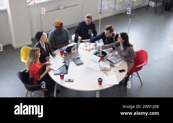 Six young successful and creative multi ethnic people stacking hands ...