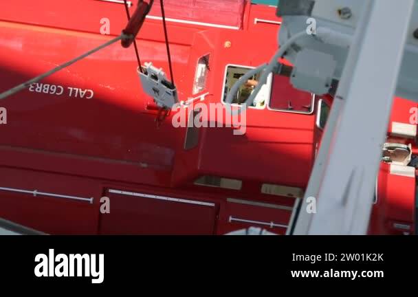 Red lifeboat is lowered into the water - Tortola, British Virgin ...