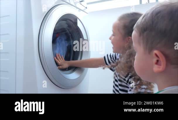 Cute Children Looks Inside the Washing Machine. Cylinder Spinning ...