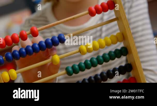 Front view of Caucasian schoolgirl learning mathematics with abacus in ...