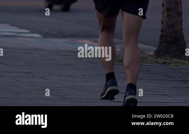 Asian man running on the street of Taipei city at nigth. Road runner ...