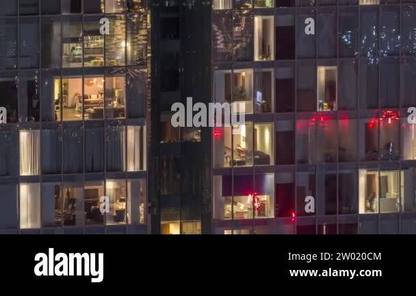Night view of exterior apartment tower timelapse. High rise skyscraper ...