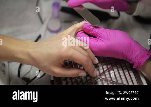 Beautician Grinds The Nail Bar For a Manicure In the Beauty Salon ...