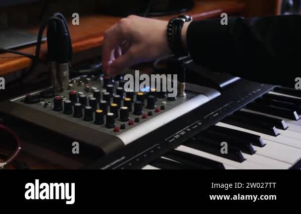 Music producer engineer turns knobs on mixing board with equalizer ...