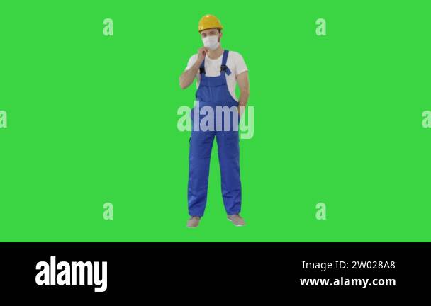 Masked construction man in hardhat on a Green Screen, Chroma Key Stock ...