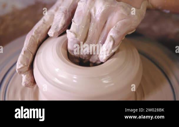 Traditional pottery making,man teacher shows the basics of pottery in ...