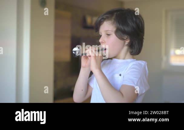 Young boy exercises with deep breathing lung exerciser. Home exercise ...