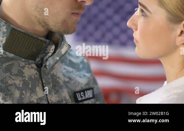 American sergeant hugging young wife before leaving work, military ...