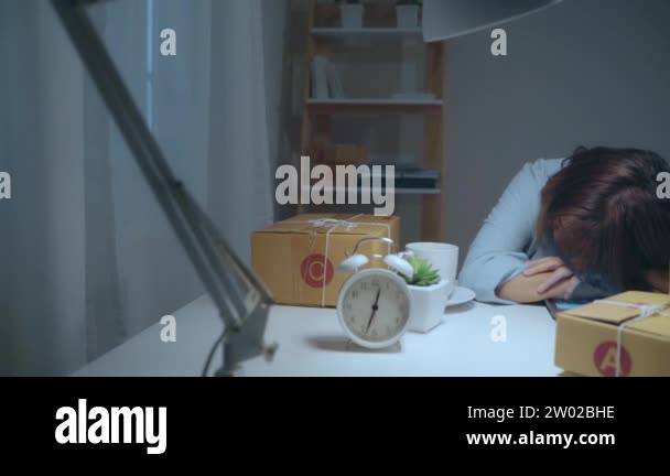 Young Asian entrepreneur business woman owner of SME sleepy exhausted ...