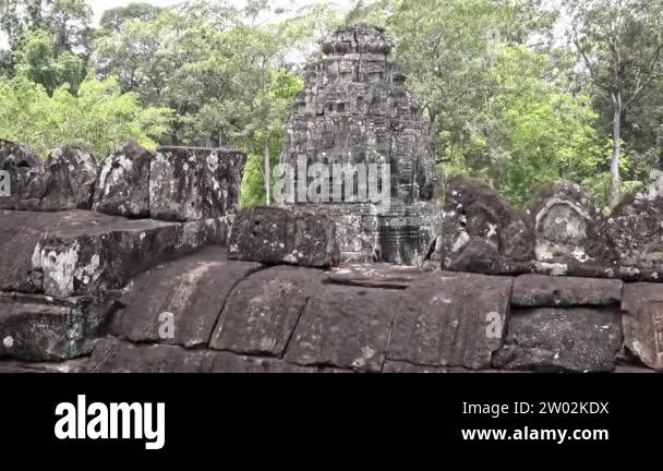 4k, Zoom in of a family of macaque climbing a face tower at Angkor Thom ...