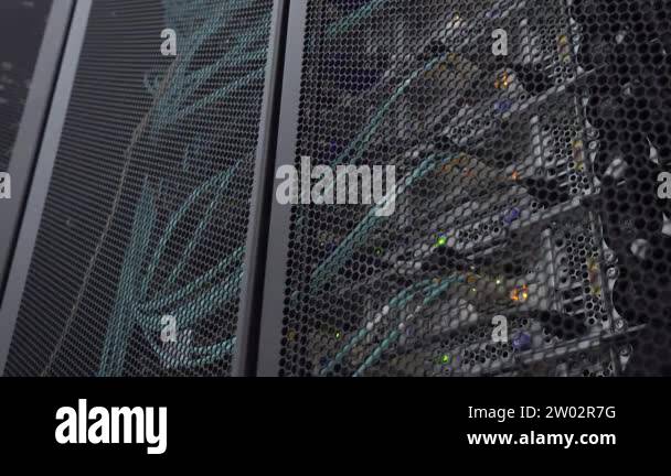 Server rack flashing led lights are in a modern data center are located behind an iron door with ...
