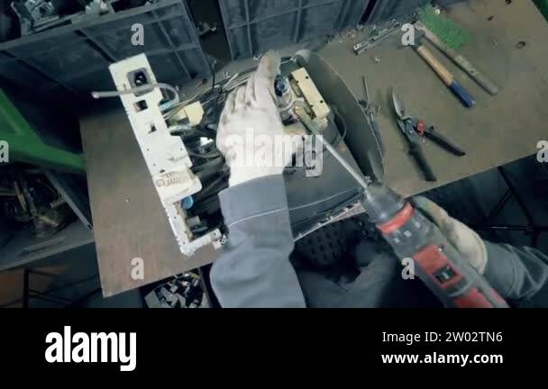 Dumpsite employee is dismantling an old computer monitor. Recycling ...