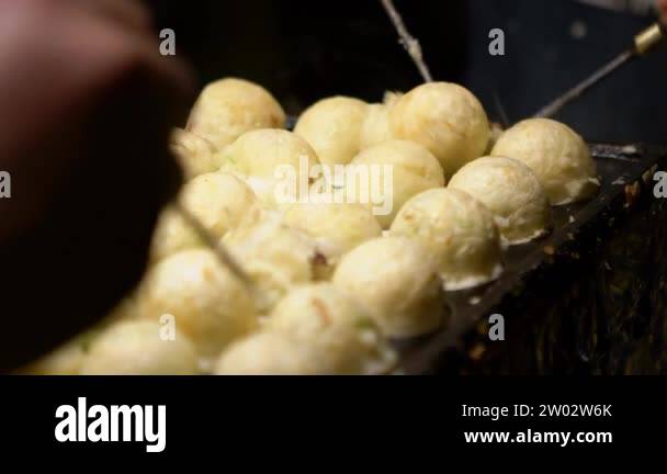 Slow Motion Japanese vendor prepare a Takoyaki on hot pan food Japan ...