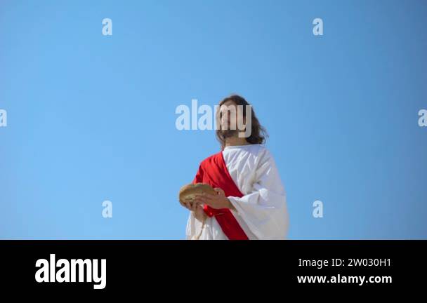 Jesus God raising bread in hands to sky, blessing sacramental food ...