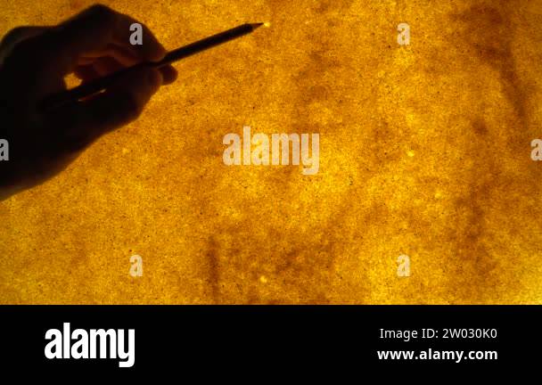 men's hands draw on the sand international symbol of peace. the concept ...