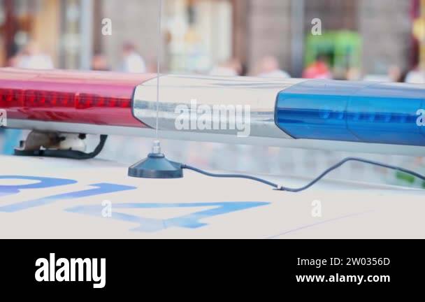 Police blue and red flashing lights on the city street, close-up ...