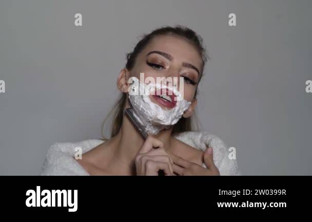 Lady shaves her face with sharp blade of straight razor. Woman with ...