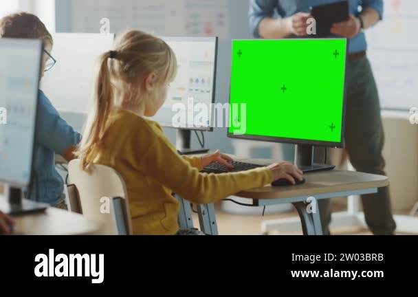 Elementary School Computer Science Classroom: Cute Little Girl Uses ...