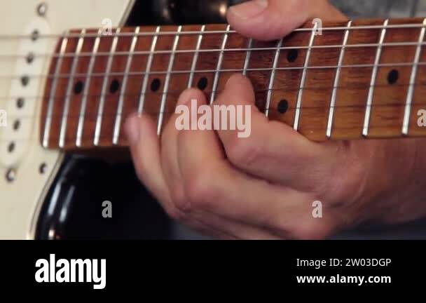 Close-up of a guitarist's hand on the guitar fretboard playing showing ...