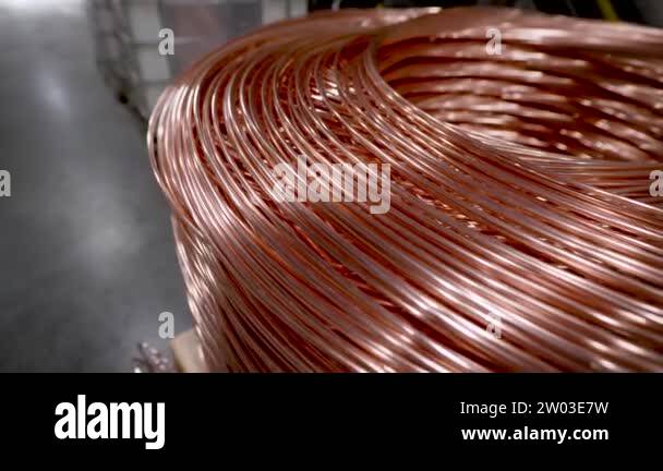 Copper rod. Thick copper wire coiled into a huge bobbin. Copper is one ...