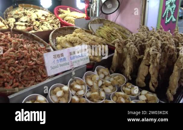 4k Asian food stand sell fried squid and other traditional fish food in ...