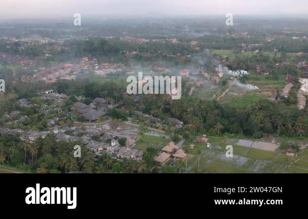 drone dolly over the jungle of Ubud in Bali, palm trees and houses with ...