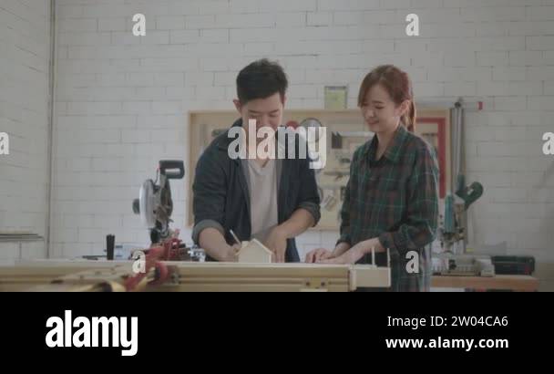 Two carpenter teamwork building design wood house model measure scale size, wooden working in ...