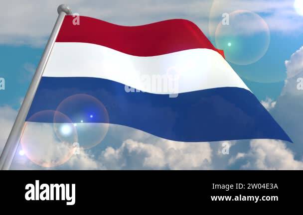 The flag of the state of the Netherlands develops in the wind against a ...
