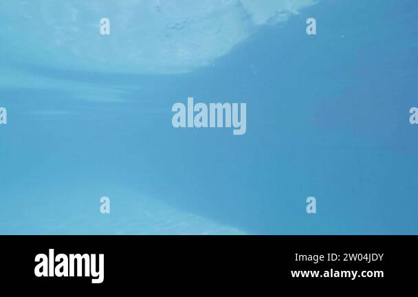 Young man diving on blue water in swimming pool slow motion. Underwater ...