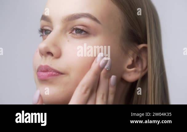 Young Pretty Woman Applies Face Cream On Her Cheekbones Applying Cream