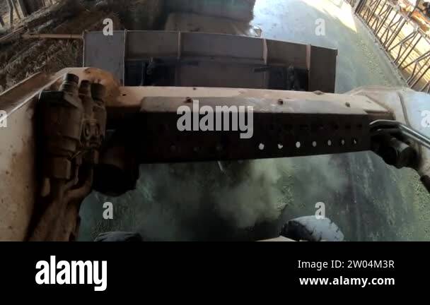 4K, Dairy farmer driving tractor in modern stable. Peasant work with ...