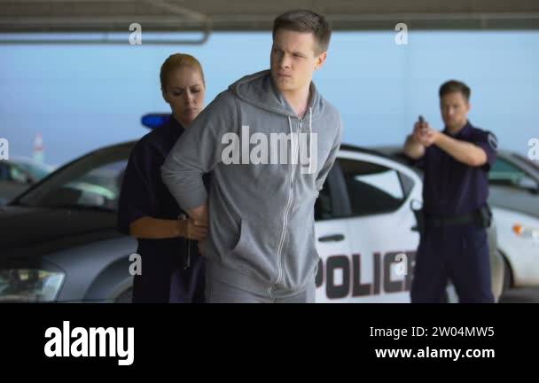 Cops arresting criminal, male officer aiming gun, police woman wearing ...