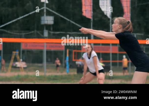Four girls playing volleyball on the beach. Beach volleyball, net ...