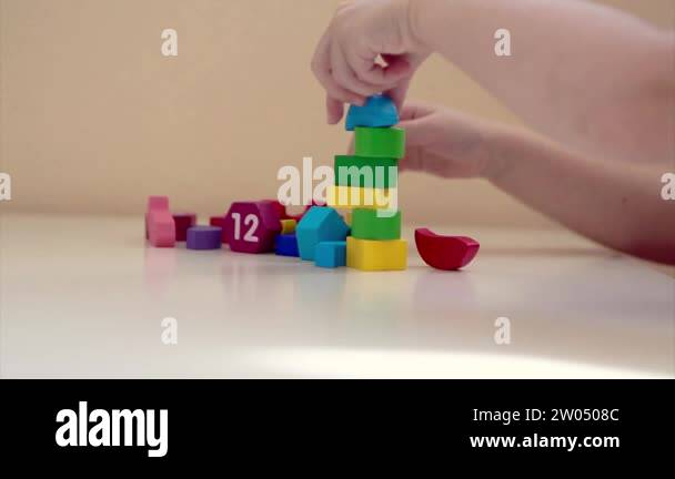 the child collects a pyramid. Details of the toy in the hands. Concept ...