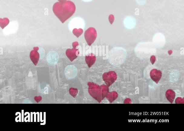 Digital composite of floating heart balloons and circle light effects ...