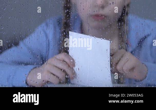 Sad little girl hugging family photo, orphan child missing parents in ...