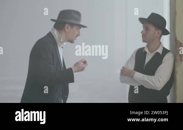 Portrait two adult confident men in fedora hat standing in the broken ...