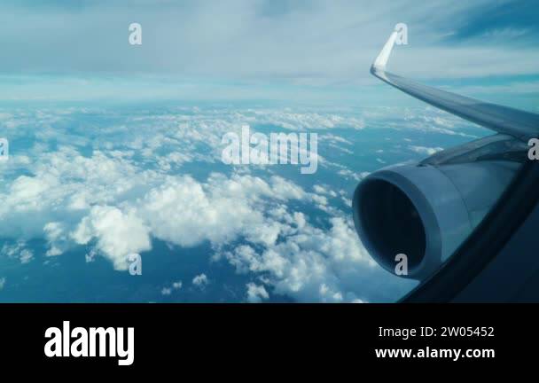View through the window of an airplane of the wing and turbine ...