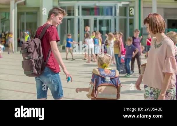 Mom and daughter say bye to each other on her first day of school. Then ...