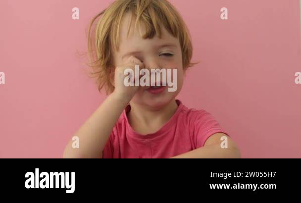 Cute child rubbing eye with plump hand Stock Video Footage - Alamy