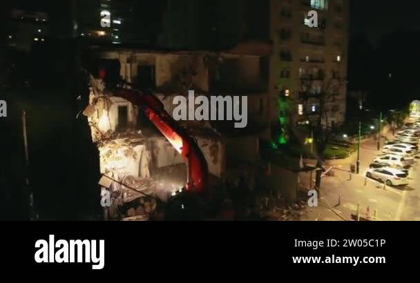 Excavator Destroying Concrete Wall. Aerial shot above. Excavator ...