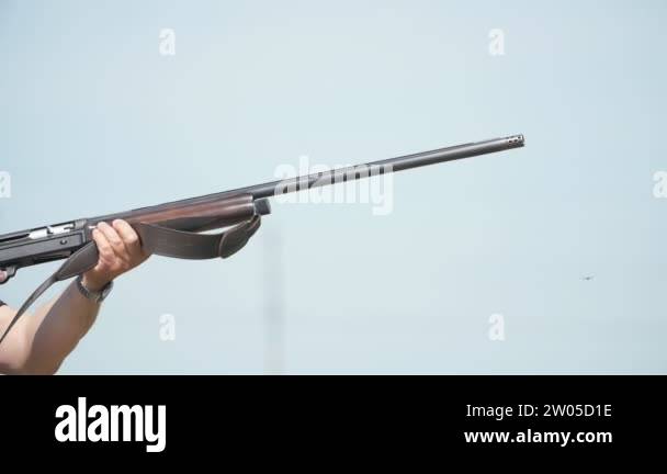 Rifle shooting at clay pigeons and case flying out of the breaching ...