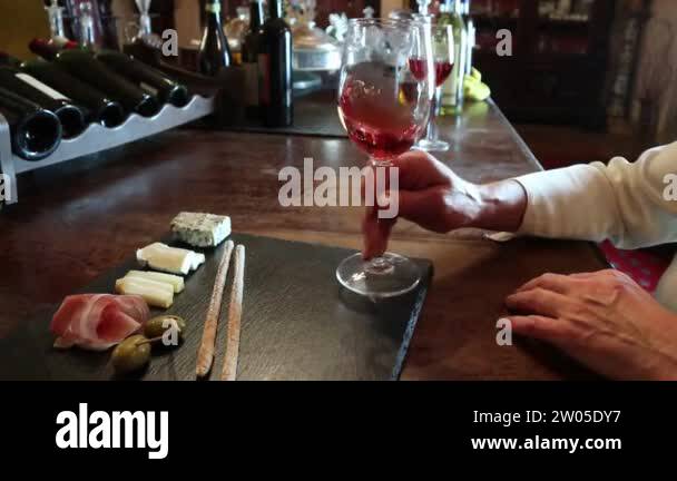 Wine test, crystal glass, red wine, cheese, bar counter background ...