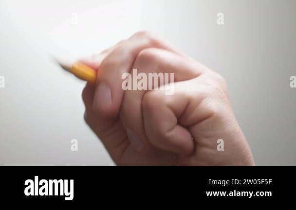 The artist drawing a flat line with a black pencil. Artists hands ...