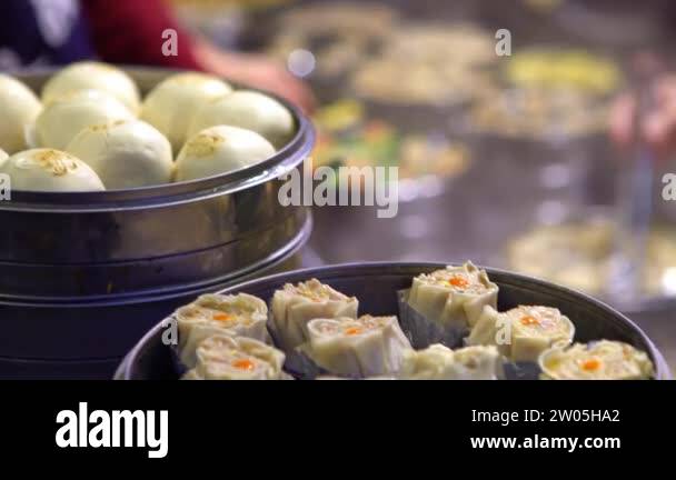 4K Vendor preparing and selling Shaomai and customers at Asian Street ...