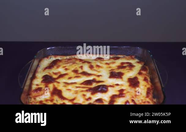 Greek moussaka dish recipe preparation. Vertical panning shot on a ...