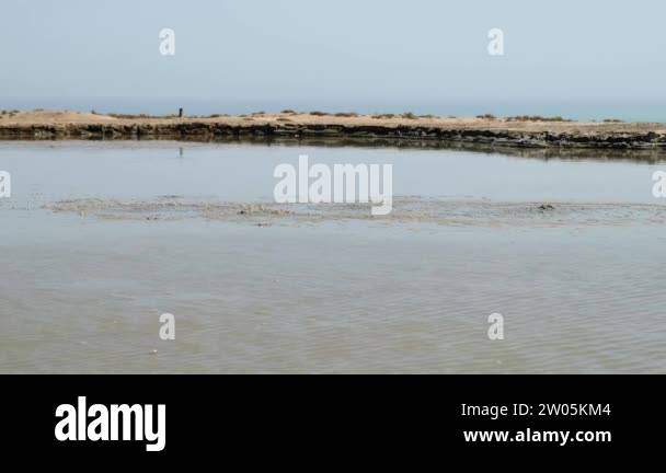 Crater of mud volcano bursting bubbles with natural gas. Famous nature ...