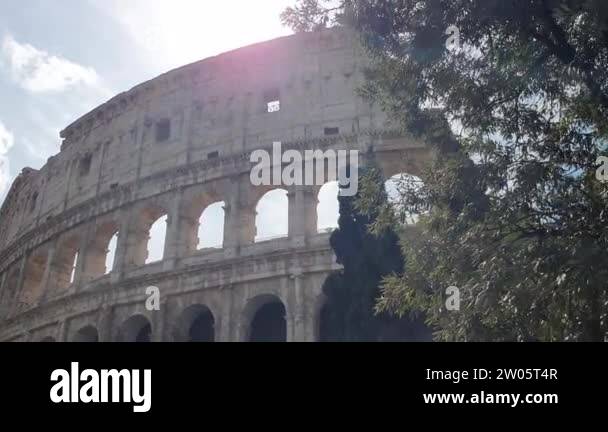 A ray of sun passes through the arches of the Colosseum in Rome, Italy ...