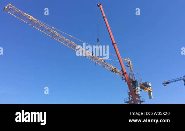 Worker installing jib on a building crane. Industrial scene in 4k ...
