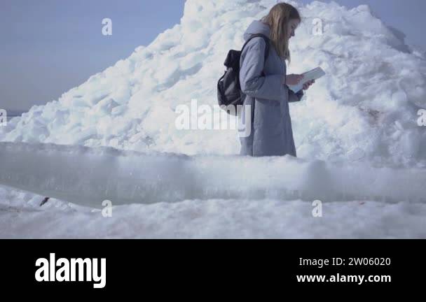 Young sad blond pretty woman in warm jacket slipping while walking on ...